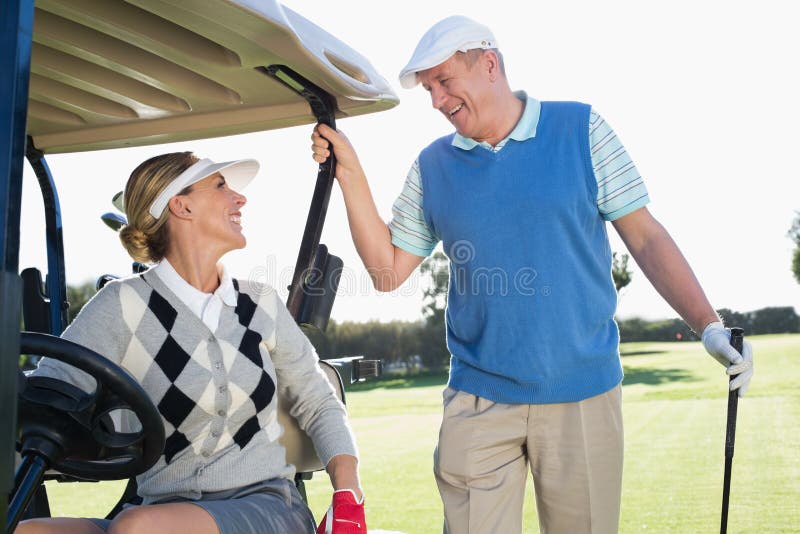 Happy Golfing Couple Setting Out for the Day on Buggy Stock Photo ...