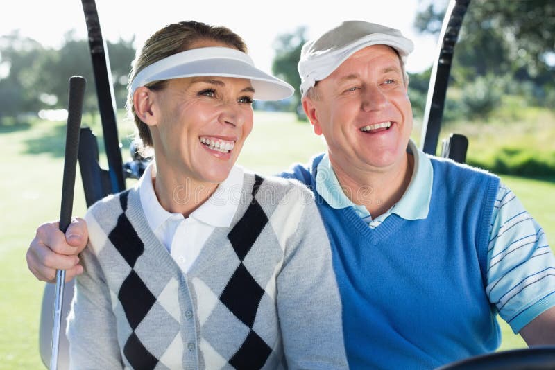 Happy Golfing Couple Sitting in Golf Buggy Smiling Stock Photo - Image ...
