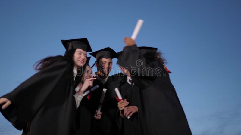 Happy Graduating Students Multi-ethnic Group is Hugging and Doing High ...
