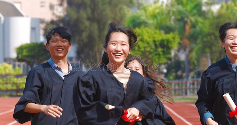 Happy Graduation Students Holding Diploma and Running on the Stadium at ...