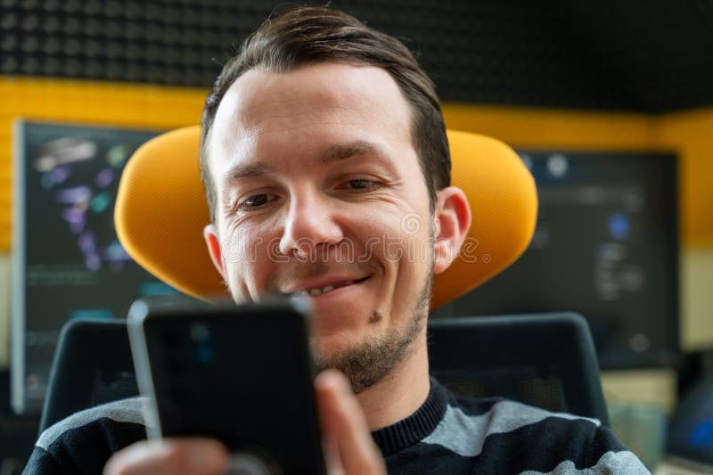 Smiling Man Reading Message on Smartphone in Creative Tech Environment ...