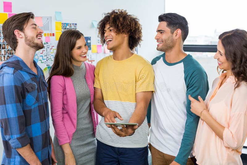 Happy Graphic Designers Interacting while Using Digital Tablet Stock ...