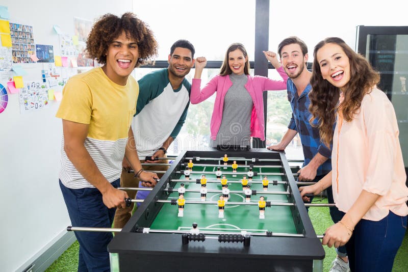 Happy Graphic Designers Playing Table Football Stock Image - Image of ...