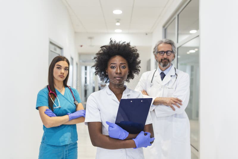Happy Group of Doctors at the Hospital Looking at the Camera Smiling ...