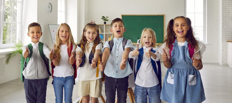 Happy Group Elementary School Students Showing Thumbs Up Standing ...