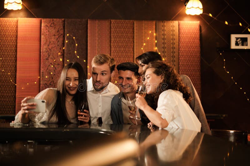 Happy Group of Friends at the Bar Having Drinks. Stock Image - Image of ...