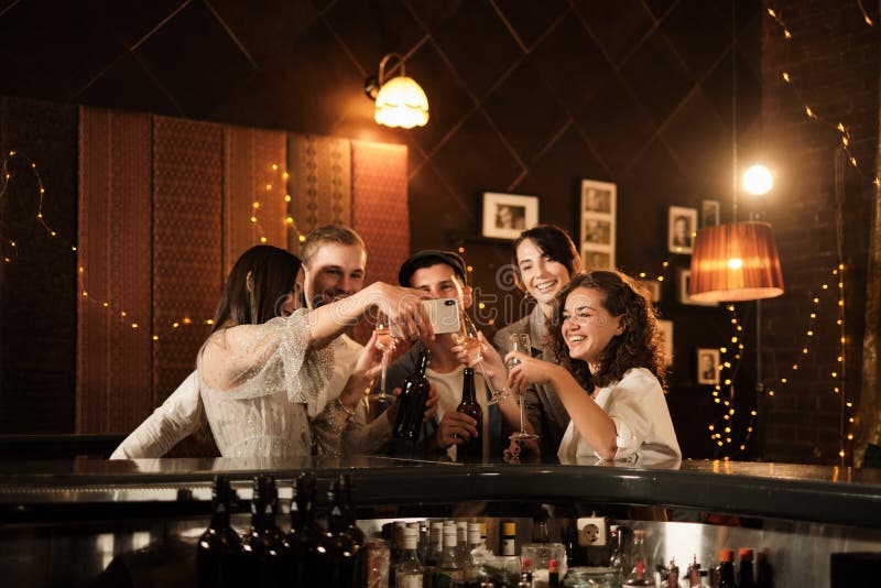 Happy Group of Friends at the Bar Having Drinks. Stock Image - Image of ...