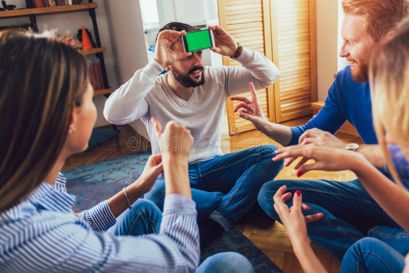 Group of Friends Playing Charades at Home Stock Image - Image of parlor ...