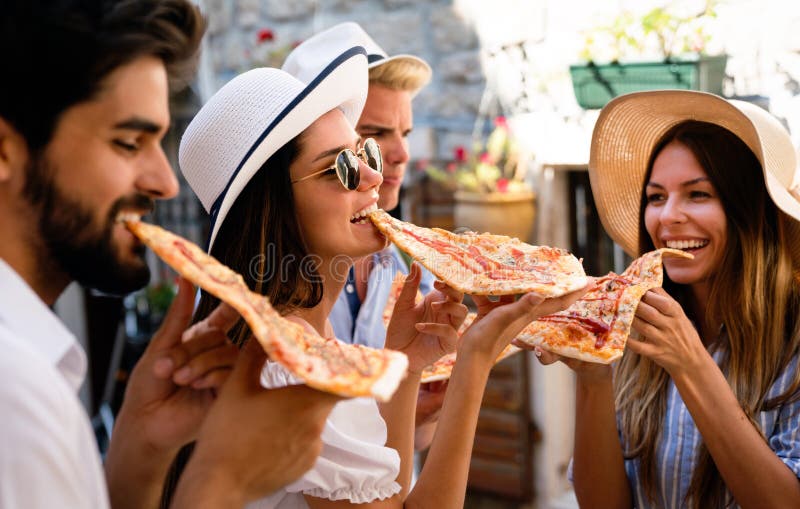 Happy Group of People Eating Pizza Outdoors,they are Enjoying Together ...