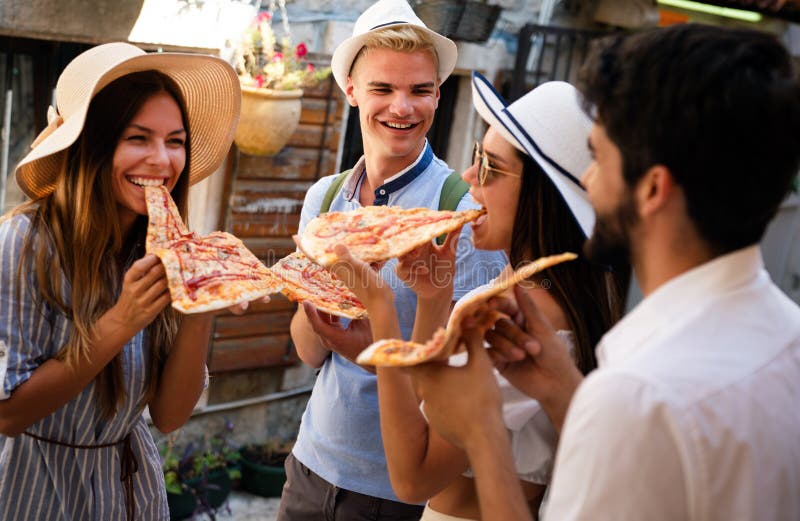 Happy Group of People Eating Pizza Outdoors,they are Enjoying Together ...
