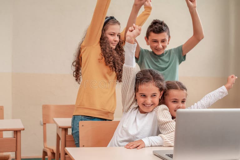 Happy Group of Student Using a Laptop at the School Class in the ...
