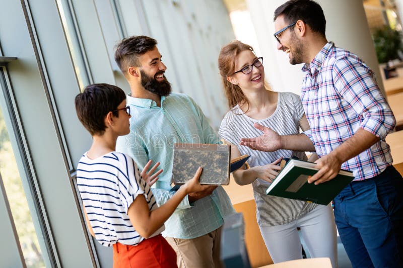 Happy Group of Students Studying and Working Together in a College ...