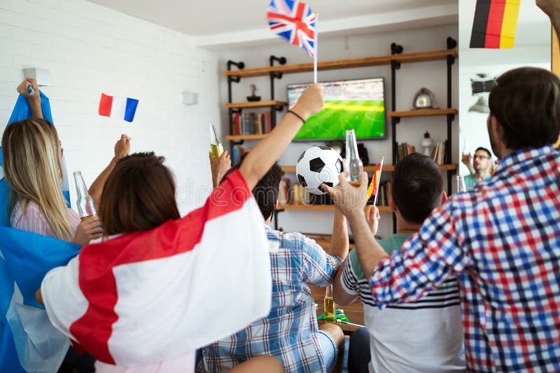 Happy Group of Young Friends Watching Television and Supporting Their ...
