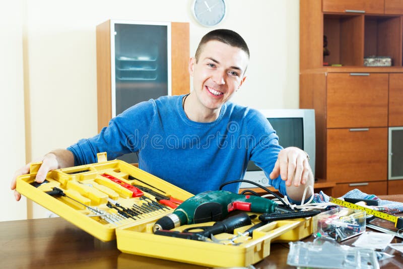 Happy Guy Doing Something with Toolbox in Home Stock Photo - Image of ...