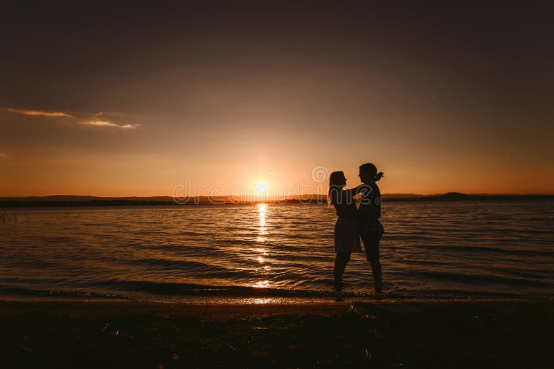 Guy and Girl Hugging the Sea at Sunset Stock Image - Image of romantic ...