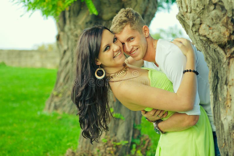 Happy Guy with the Girl Look Out because of a Tree Stock Photo - Image ...