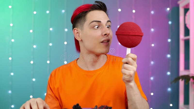 Happy Guy Holding a Big Lollipop in His Hands Stock Video - Video of ...