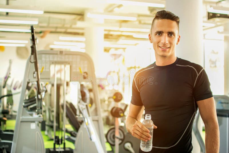 Happy Guy Holding Bottle of Water in Gym Stock Image - Image of ...