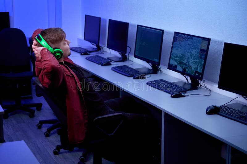 The Happy Guy Leans on the Back of the Chair, Hands Behind His Back and ...