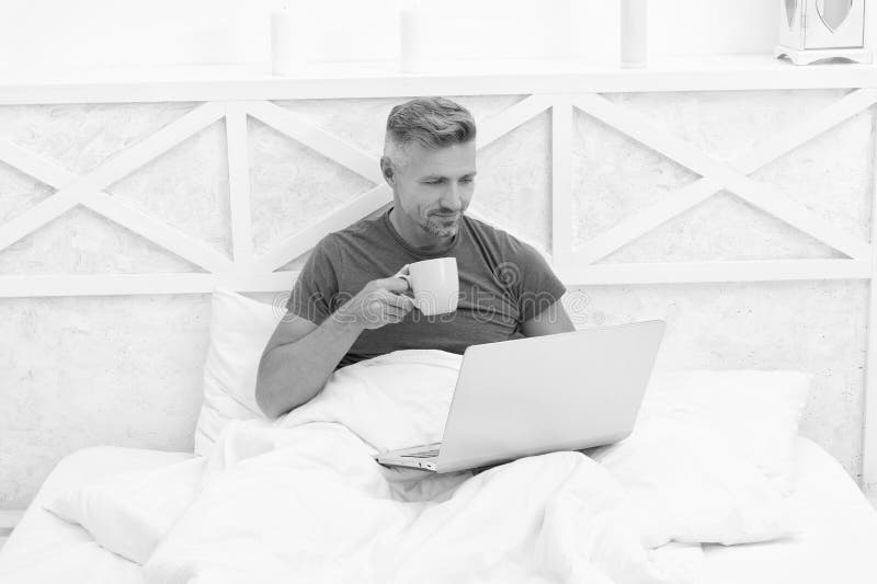 Happy Guy Relax Drinking Morning Tea and Using Laptop Computer in Bed ...