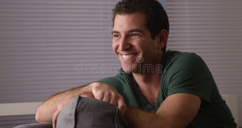 Happy guy sitting on couch stock image. Image of happiness - 44820811