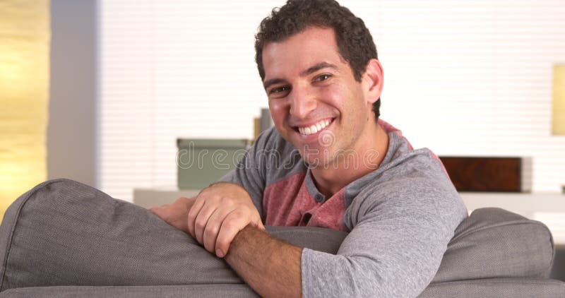 Happy guy on couch stock photo. Image of sitting, thinking - 85203548