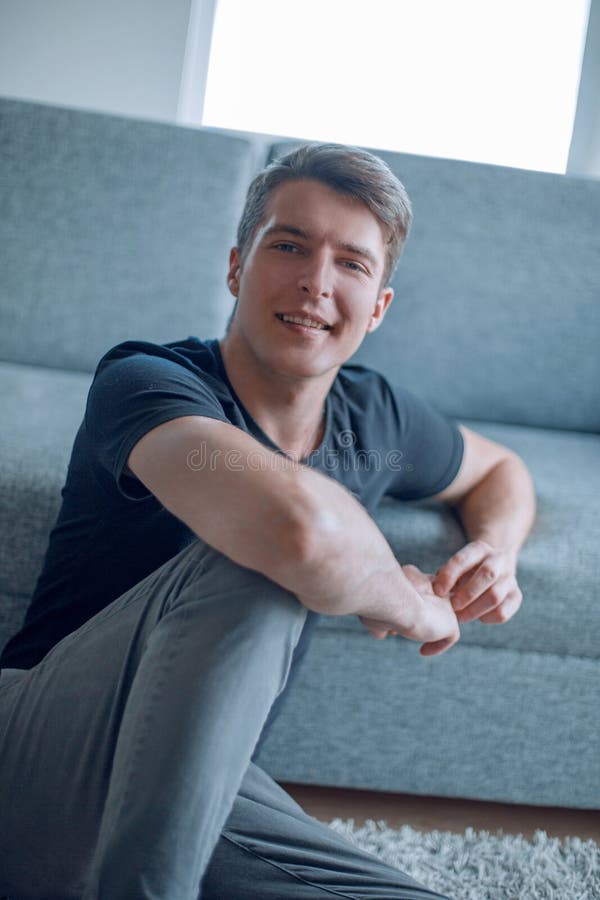 Happy Guy Sitting on the Floor and Looking at the Camera Stock Image ...