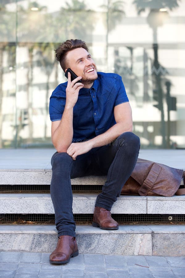 Happy Guy Sitting Outside with Cell Phone Stock Photo - Image of face ...
