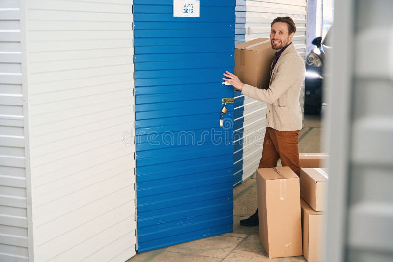 Young Man with Big Cardboard Boxes in Self Storage Unit Stock Photo ...