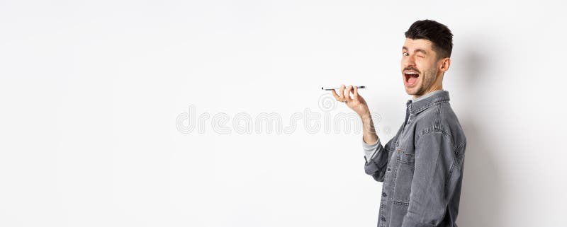 Happy Guy Winking at Looking at Camera while Using Voice Translator App ...