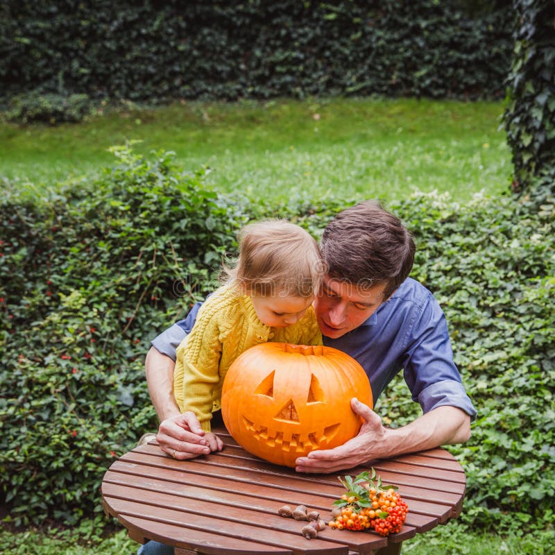 Happy Halloween Father And Daughter Look Inside The Carved Pumpkin For