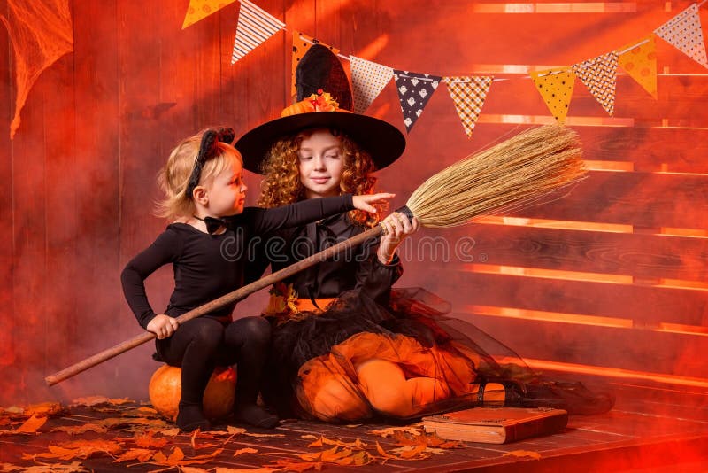 Happy Halloween. Two Cute Cheerful Witches are Considering a Magic ...