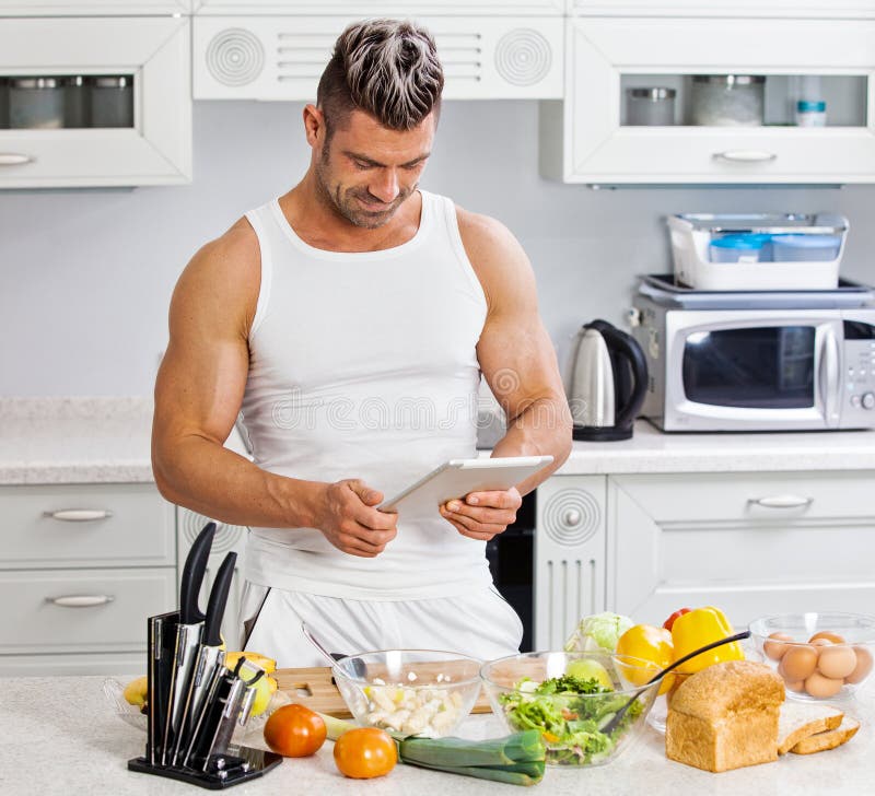 Happy Handsome Man Cooking in Kitchen at Home. Stock Photo - Image of ...