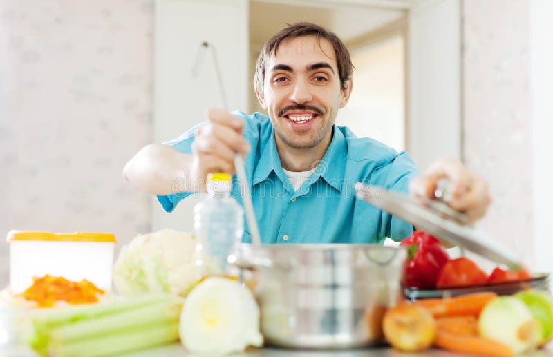 Happy Handsome Man Cooks Lunch Stock Photo - Image of preparing ...