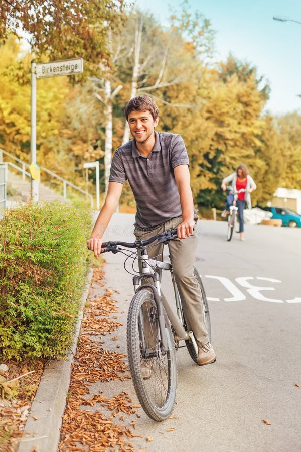 Happy handsome man cycling stock photo. Image of nature - 61053984
