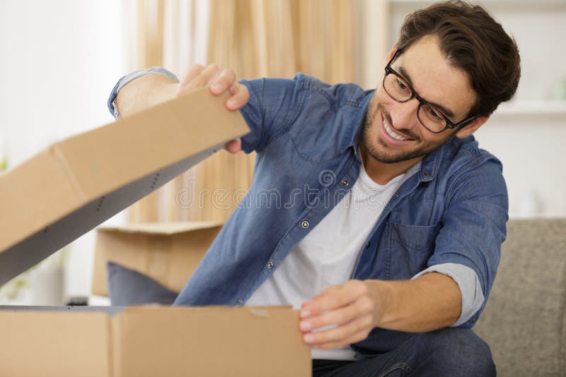Happy Handsome Man Opening Parcel Stock Photo - Image of postal, goods ...