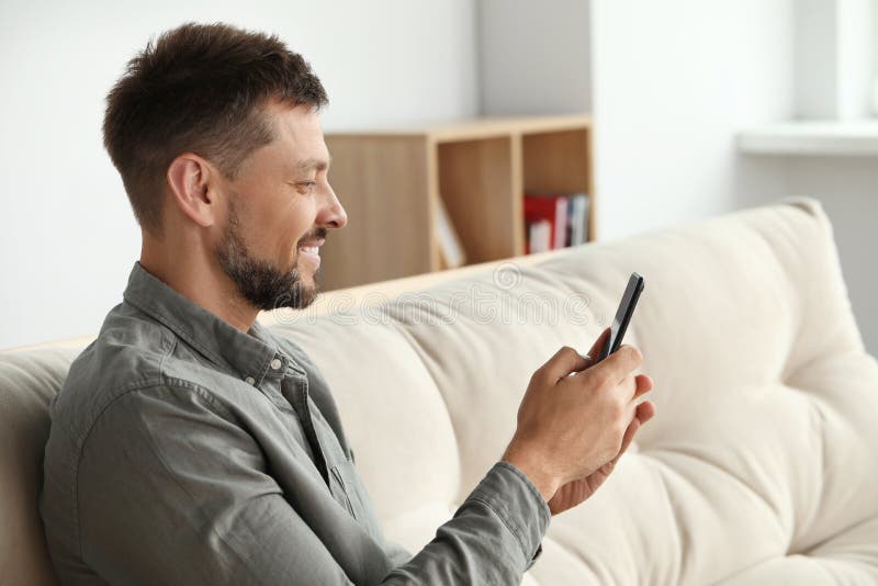 Happy Handsome Man Using Smartphone at Home Stock Photo - Image of ...