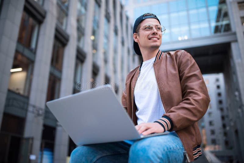 Smart Attitude. Positive Handsome Man Using a Laptop and Sitting in the ...