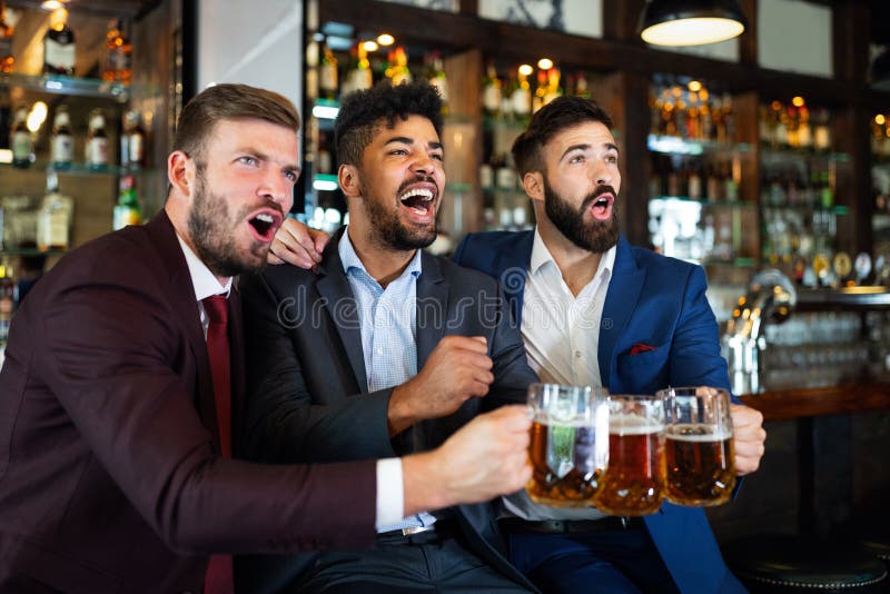 Happy Young Businessmen Drinking Beer and Talking at Pub after Work ...