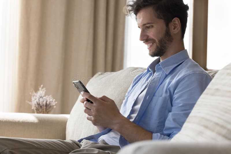 Happy Handsome Young Man Browsing Internet on Mobile Phone Stock Photo ...