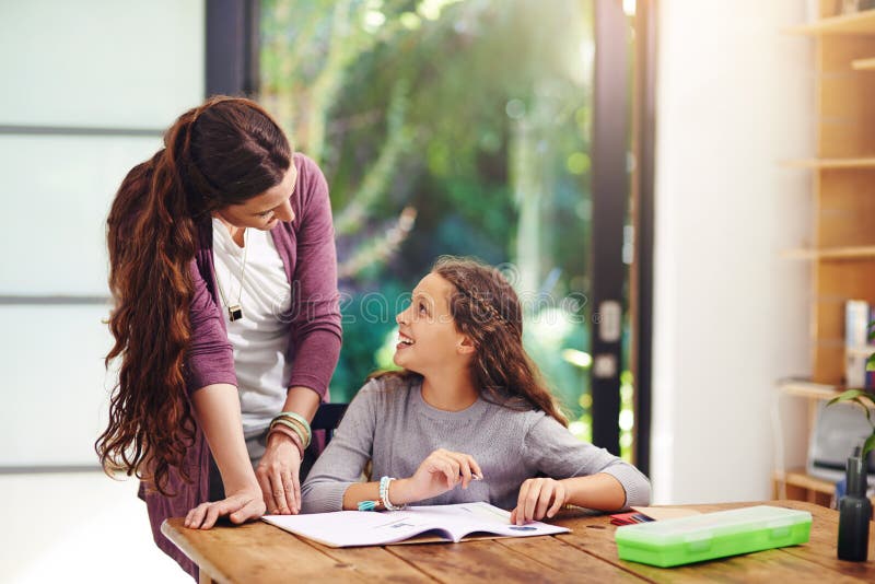Happy when Her Mother Helps Her with Her Homework. a Young Girl Doing ...