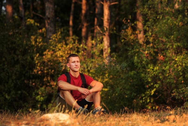 Happy Hiker Man Sitting on the Ground and Looking Forward Stock Photo ...