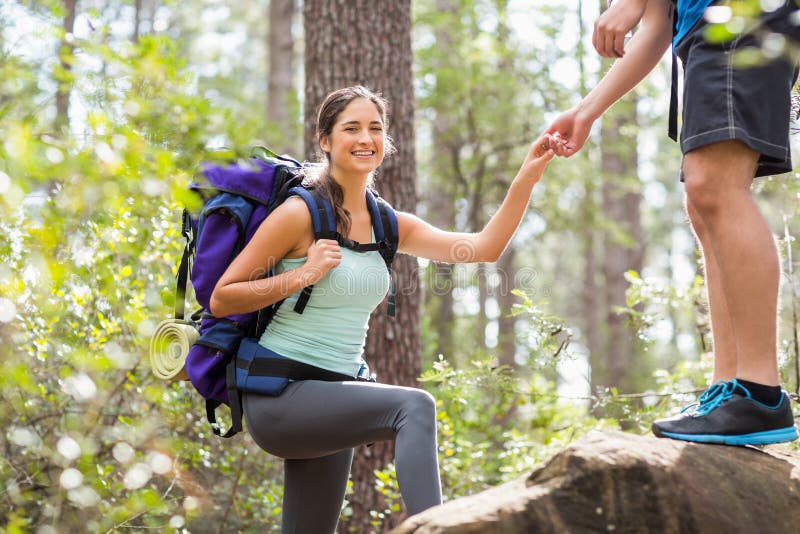 Happy Hikers Climbing on Rock and Smiling at Camera Stock Photo - Image ...