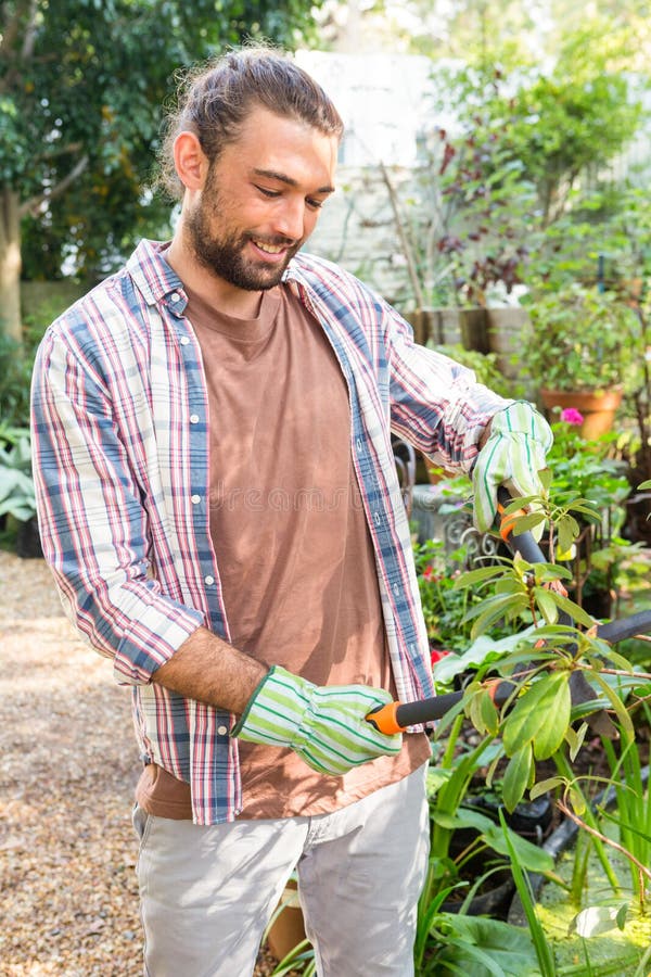 Happy Hipster Cutting Twigs at from Clippers at Garden Stock Photo ...