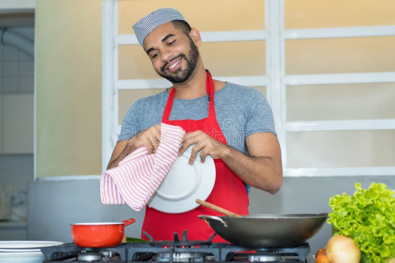 Happy Hispanic Kitchen Assistant Cleaning Plates at Work Stock Photo ...