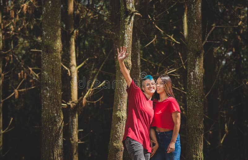 Happy Hispanic Lesbian Couple Hugging in a Forest Stock Image - Image of woods, trees: 254607461