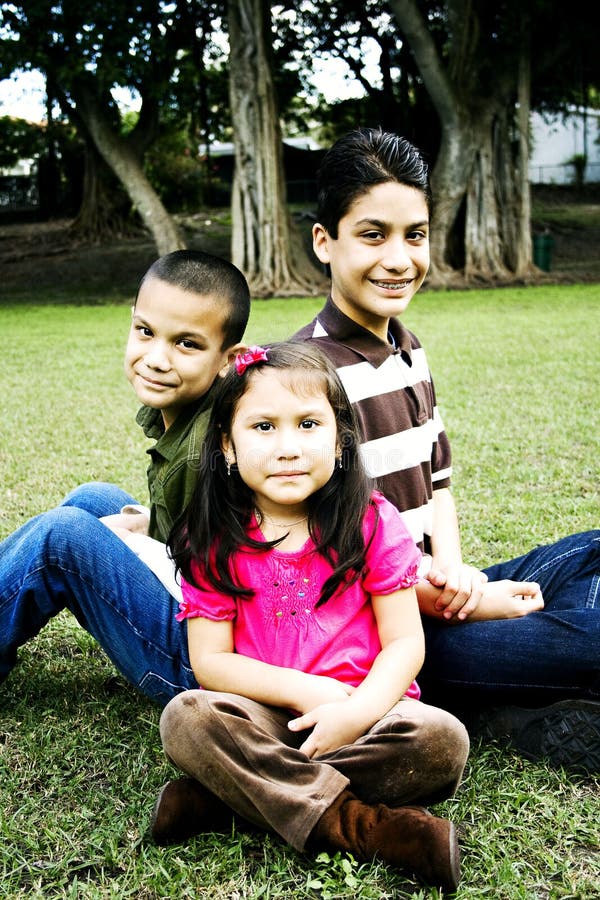 Happy Hispanic Siblings Together in Front of Tree Stock Photo - Image ...
