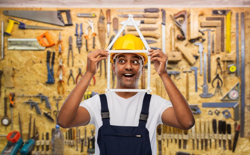 Happy Indian Builder with Ruler in Shape of Home Stock Photo - Image of ...