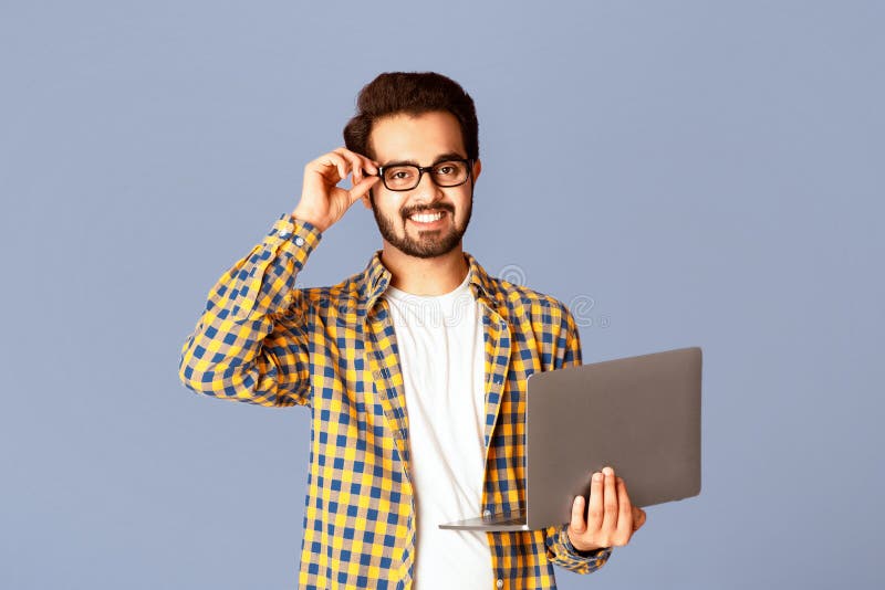 Happy Indian Guy in Glasses Using Laptop Computer for Distance Work or ...
