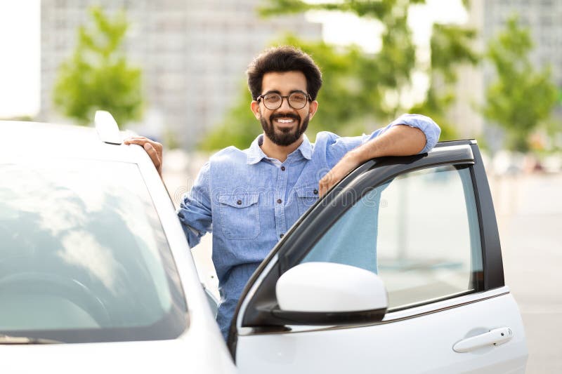 Happy Indian Guy Standing by White Car at Parking, Smiling Stock Photo ...